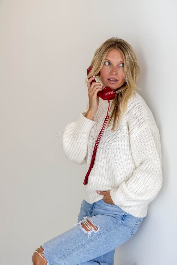 A Gorgeous Blonde Model Talks on the Phone Showing Emotion in a Home Environment Stock Photo ...