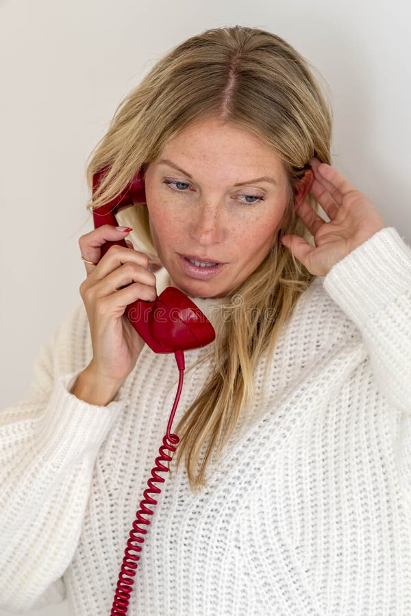 A Gorgeous Blonde Model Talks on the Phone Showing Emotion in a Home ...