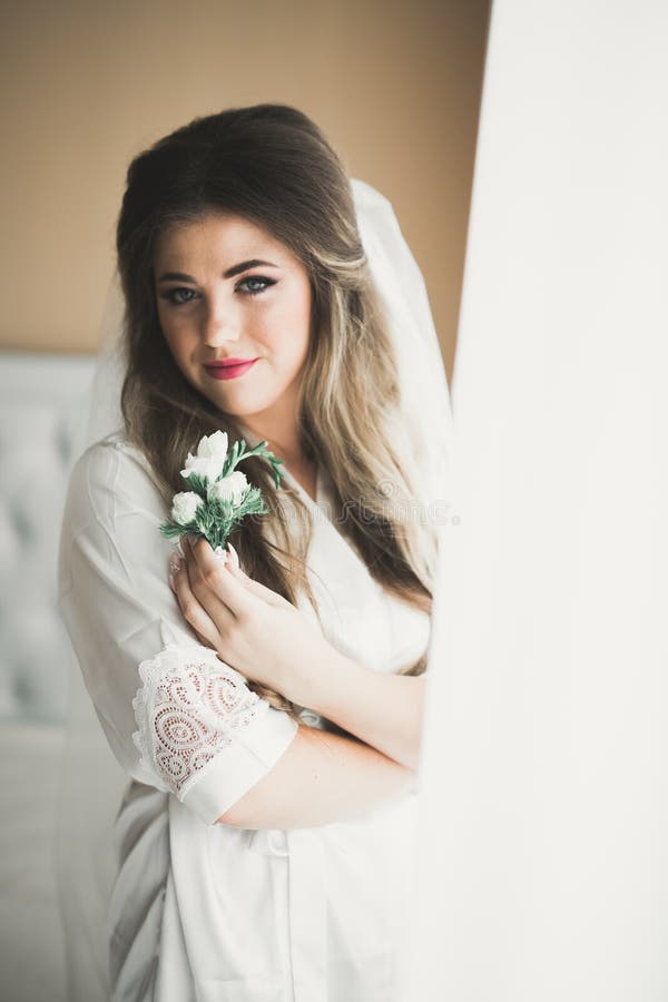 Gorgeous Bride in Robe Posing and Preparing for the Wedding Ceremony ...
