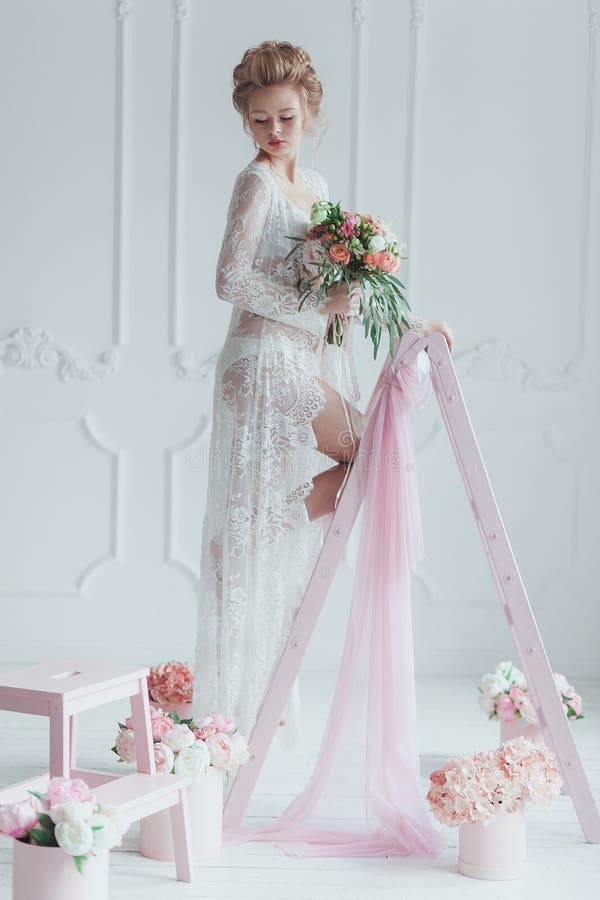 Gorgeous Bride with Wedding Bouquet Standing on the Decorated Ladder ...