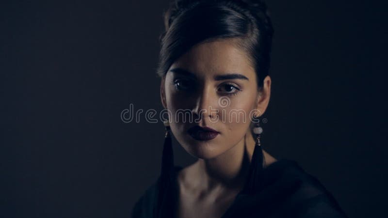 Gorgeous Brunette Woman Turning Head on Camera. Dramatic Light Stock ...