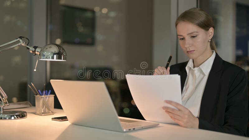 The Gorgeous Businesswoman Reading Document on Office Desk at Night ...