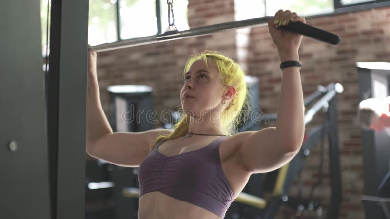 Gorgeous Female Professional Bodybuilder Doing Workout Exercises in Gym ...