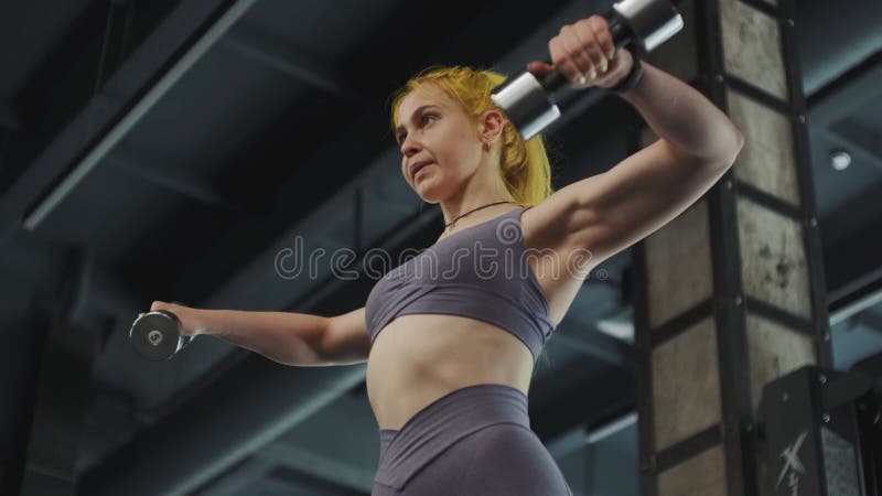 Gorgeous Female Professional Bodybuilder Doing Workout Exercises in Gym ...