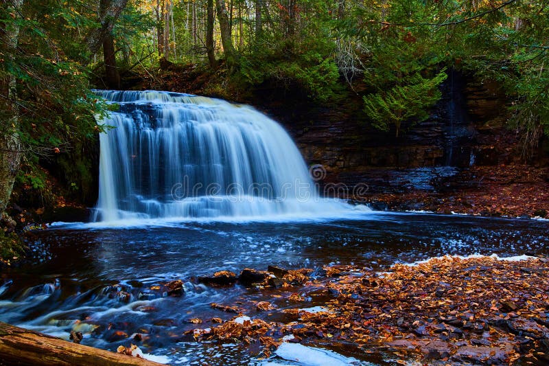 Gorgeous Large Blue Waterfall with Basin and Stream Flowing Over Rocks ...