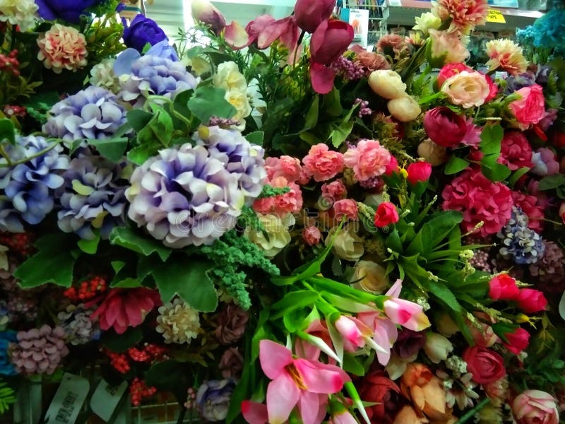 Beautiful Variety of Fake Flowers Stand in the Supermarket. Beautiful ...