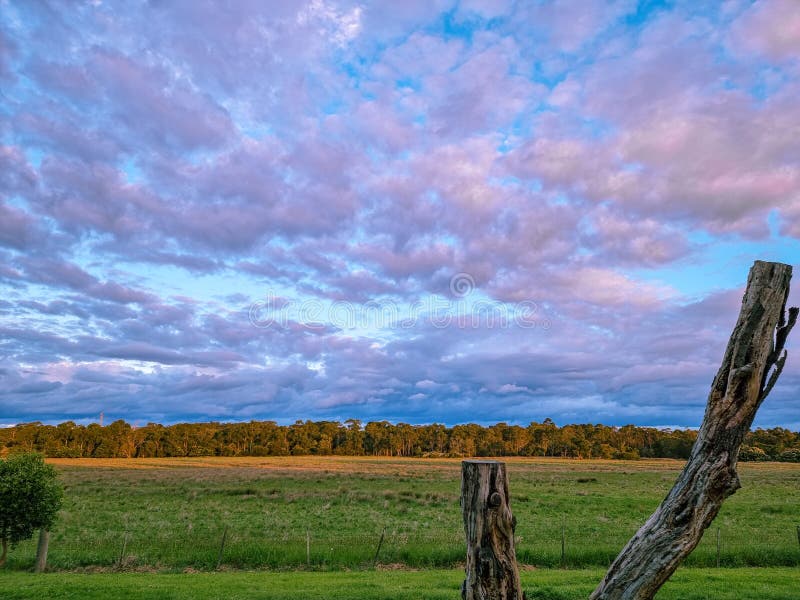 Sunset Clouds Over a Paddock Stock Image - Image of hill, paddock ...