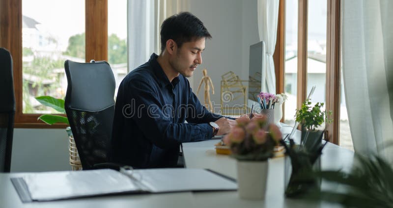 Gorgeous Young Businessman Sitting in Bright Office and Looking at ...