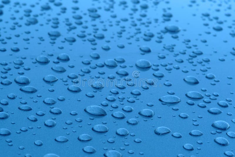 Gotas Del Agua En Superficie Azul Imagen de archivo - Imagen de gota ...