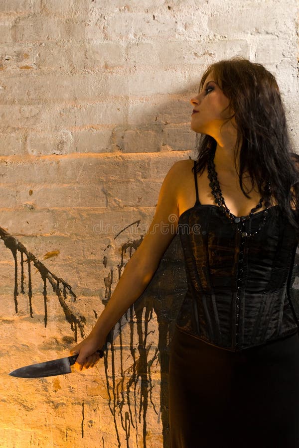 Goth woman holding knife stock image. Image of fashion - 6354699