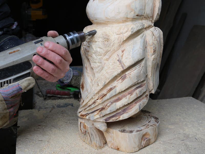 Gouging Out the Contours of a Wooden Figure with a Drill Stock Photo ...