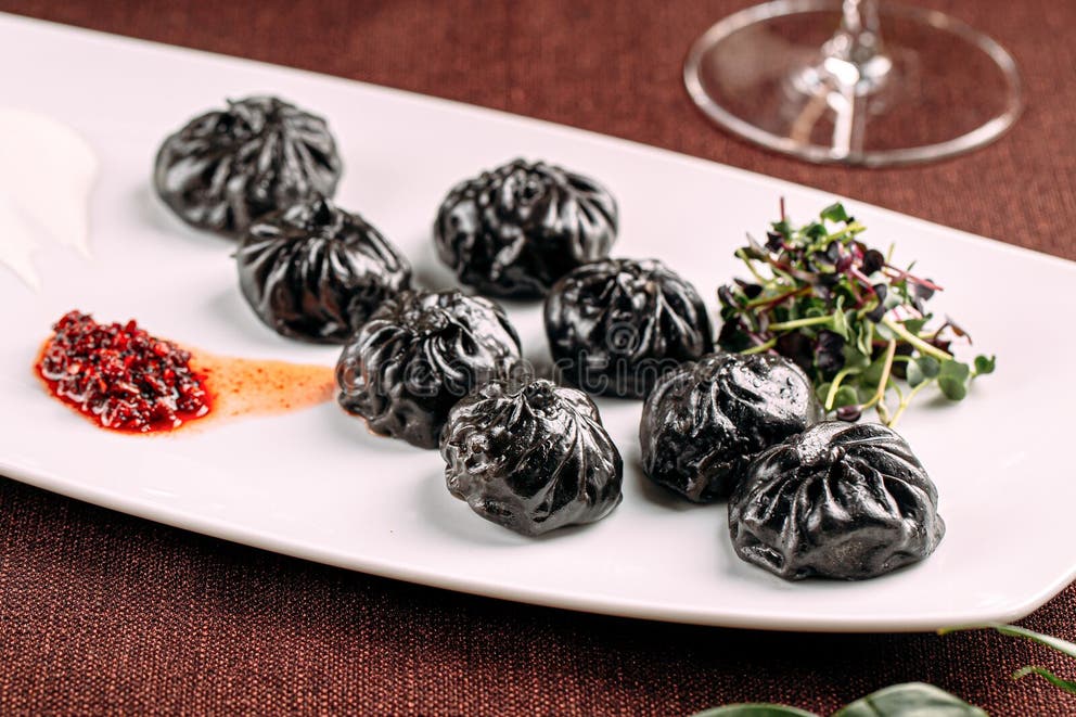 Gourmet Black Colored Dumplings with Sauce Stock Image - Image of squid ...