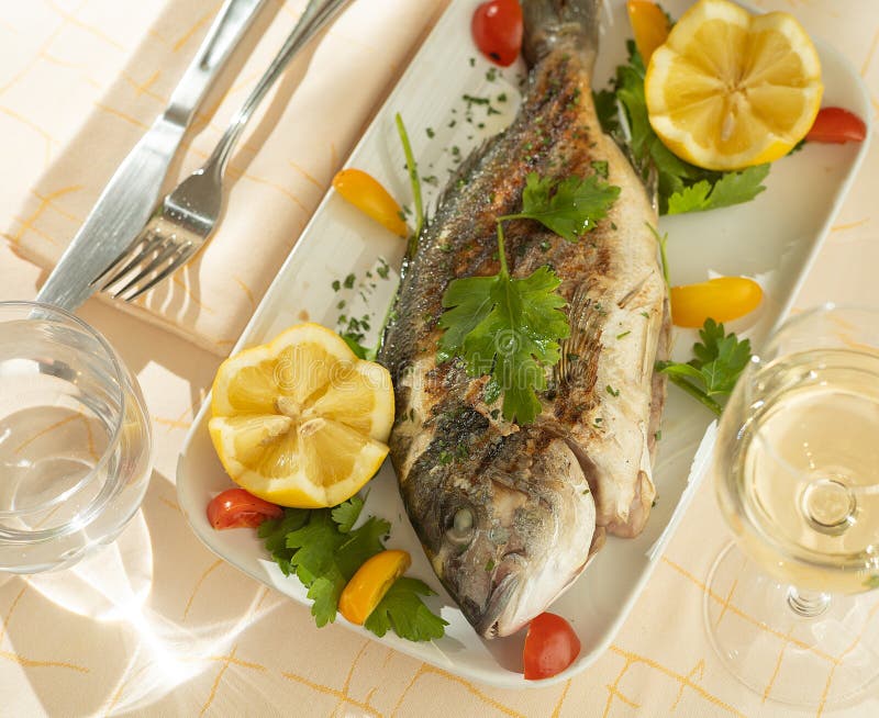 Gourmet Cooked Fish with Lemon and Herbs Stock Photo - Image of plate ...