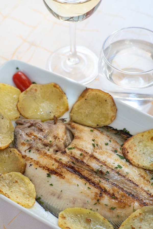 Gourmet Cooked Fish with Lemon and Herbs Stock Photo - Image of water ...