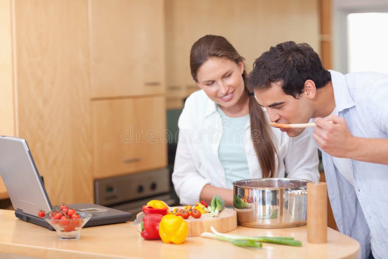 Gourmet Couple Using a Laptop To Cook Stock Photo - Image of internet ...