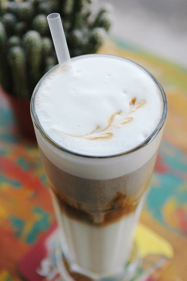 Gourmet Refresh Layered Ice Latte with Leaf Design Whipped Cream Stock ...