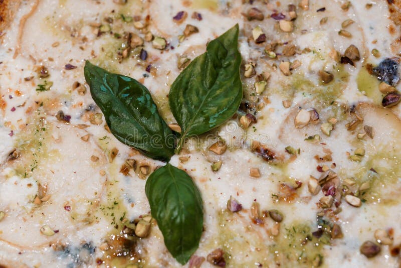 Gourmet White Pizza with Fresh Basil and Crunchy Nuts Topping Stock ...