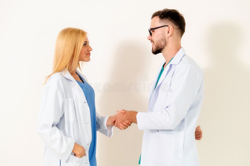 GP Doctor Shakes Hand with Surgical Doctor. Stock Image - Image of ...