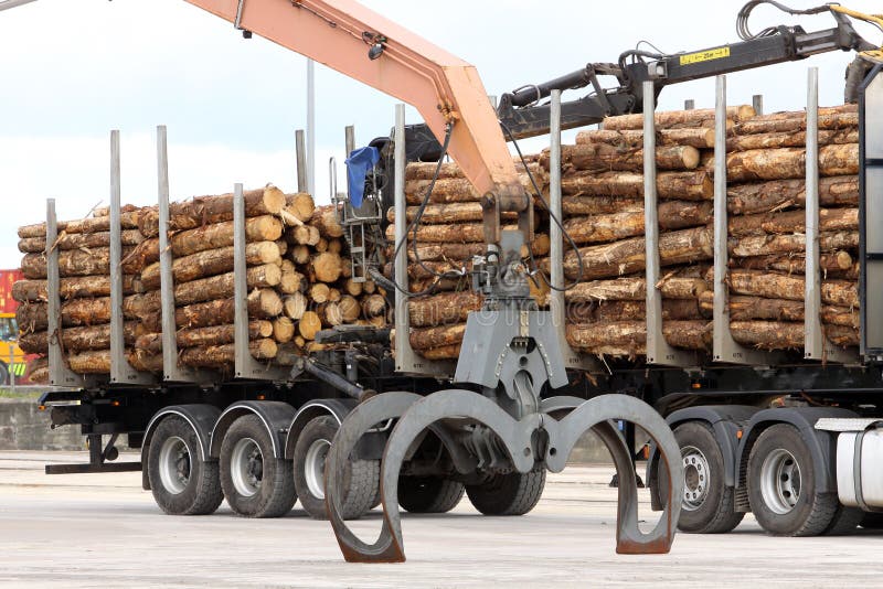 Grabber crane with timber stock image. Image of loading - 20369391