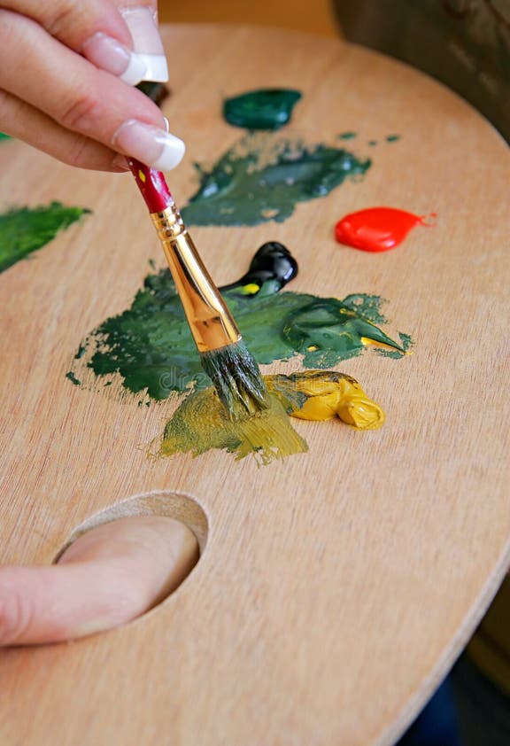 Grabbing paint off palette stock image. Image of colors - 5032759