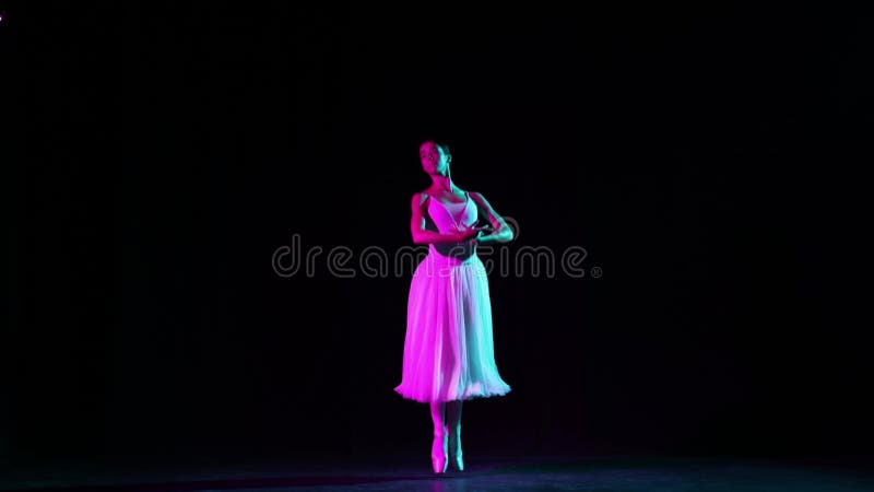 Graceful Ballerina In Elegant White Dress Practicing Base Movements In