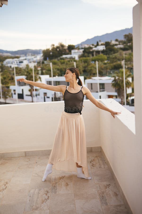 An Elegant Dancer Posing Outdoors Against a Beautiful Scenic View and ...