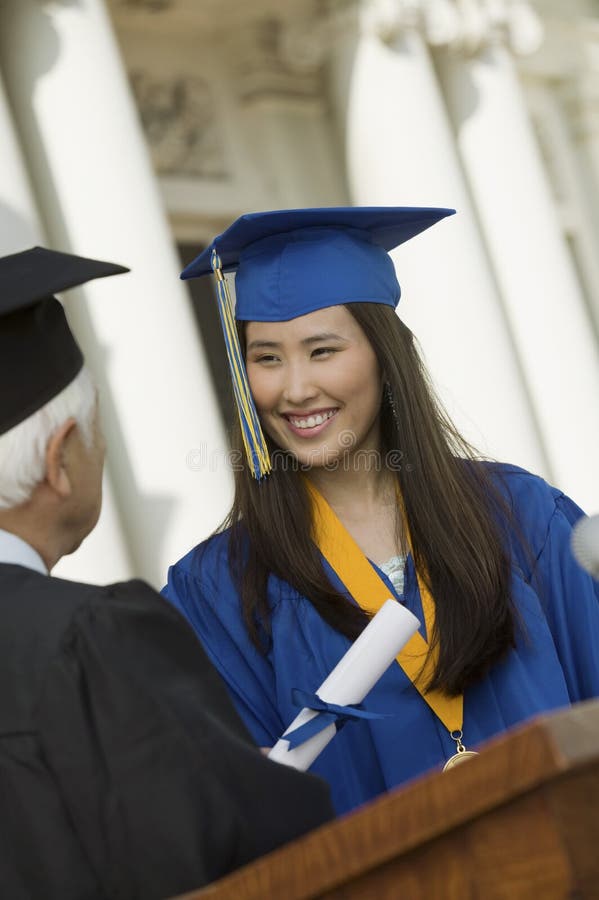 Graduate Receiving Diploma Outside University Stock Image - Image of ...