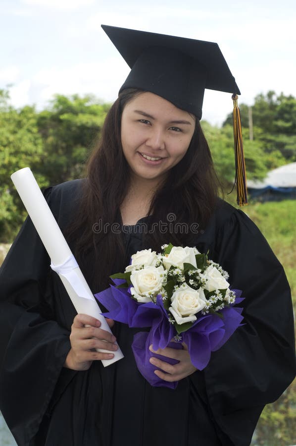 Graduate Student Holding Flowers and Diploma Stock Photo - Image of ...