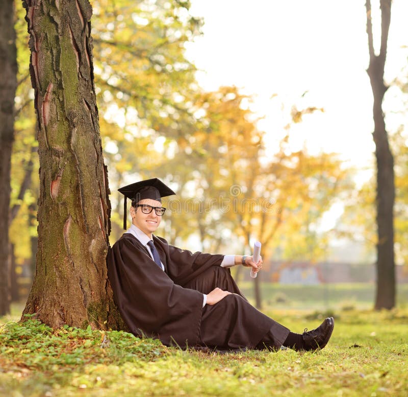 Graduate Student Sitting by a Tree in a Park Stock Image - Image of ...