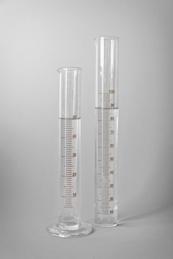 Graduated Cylinders With Water On Light Background Stock Photo - Image ...