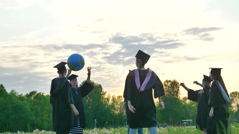 Graduates in Costume Playing with a Ball at Sunset. Stock Footage ...