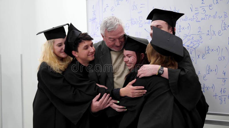 Graduates Hug with Their Professor in University. Stock Footage - Video ...