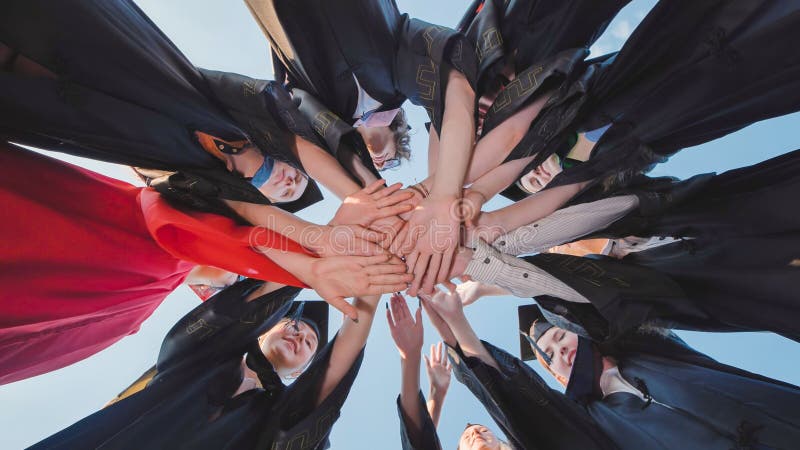 Graduates Joining Hands in a Circle from Below, Celebrating Their ...