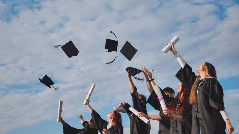 Graduating Students Hands Throwing Graduation Caps in the Air. Stock ...