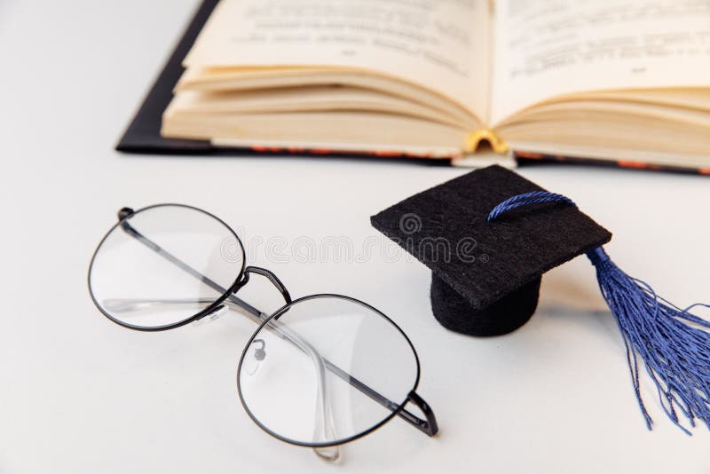 Graduation Cap and Glasses with Open Book Close-up Stock Photo - Image ...