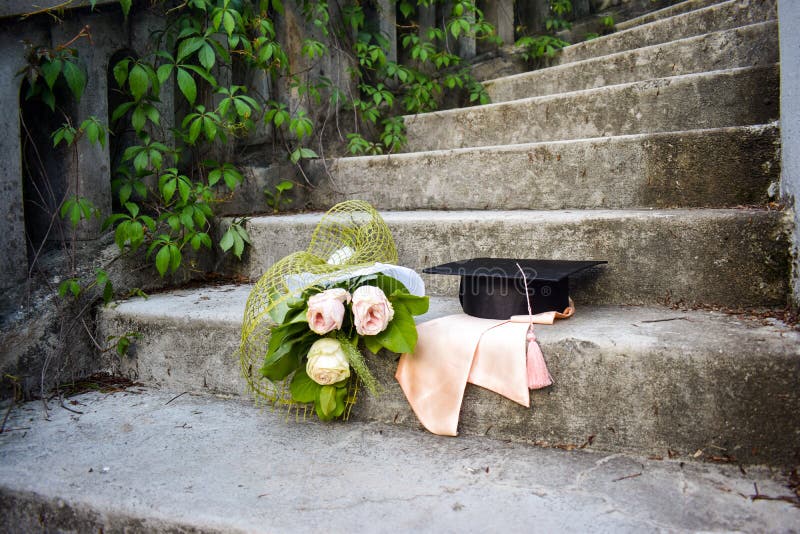 Graduation Cap or Mortaboard with a Bunch of Roses on the Old Stairs in ...
