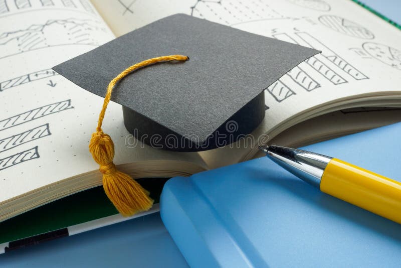 Graduation Cap on a Notebook with Business Notes. Symbol of Education ...