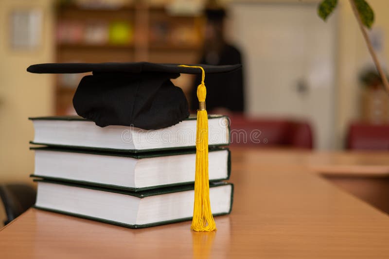 Graduation Cap on a Stack of Books in the Library. Stock Photo - Image ...