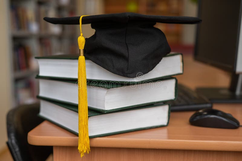 Graduation Cap on a Stack of Books in the Library. Stock Photo - Image ...