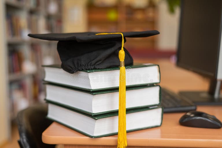 Graduation Cap on a Stack of Books in the Library. Stock Photo - Image ...