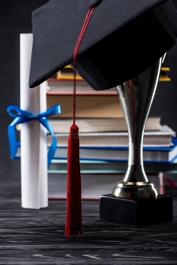 Graduation Cap on Trophy Cup in Front of Books Stock Image - Image of ...