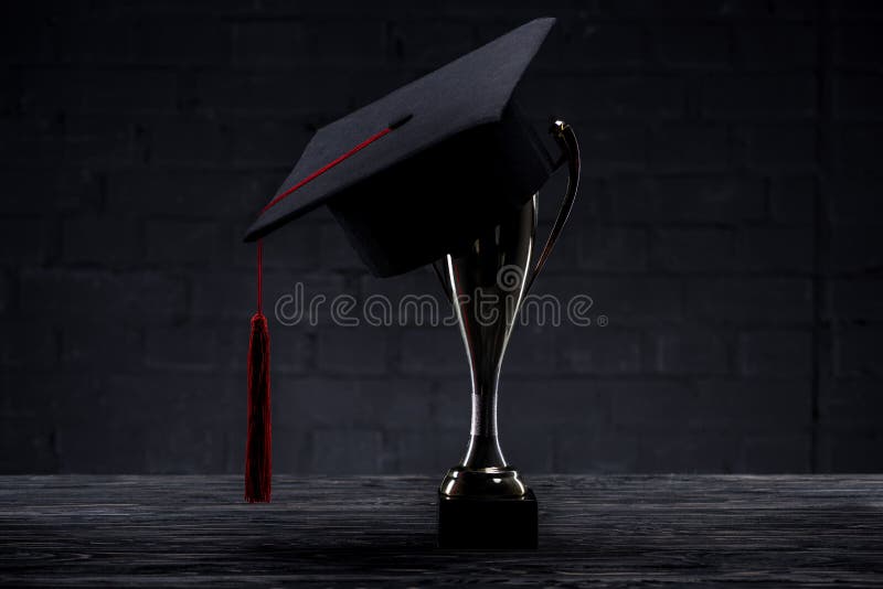 Graduation Cap on Trophy Cup by Books and Diploma Stock Image - Image ...