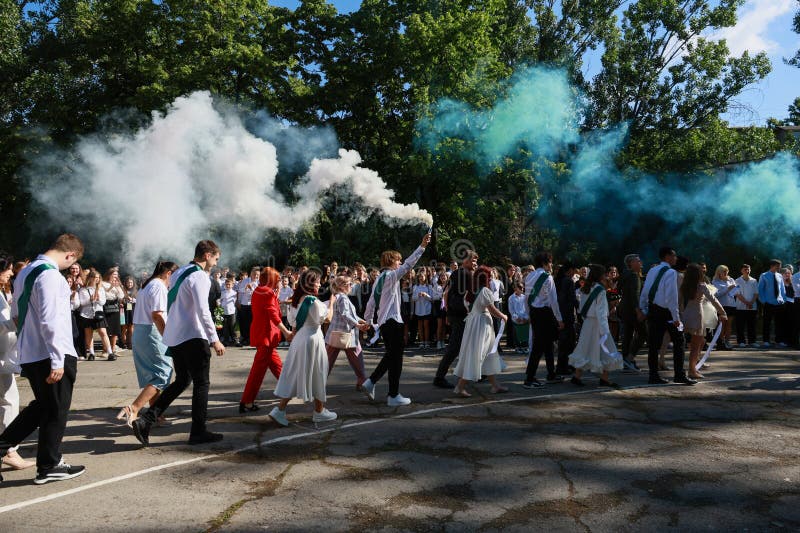 Graduation Celebration with Students Walking and Smoke in Background ...