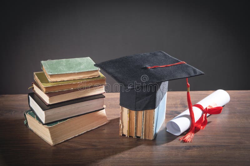 Graduation Hat, Book and Diploma on the Wooden Table Stock Photo ...