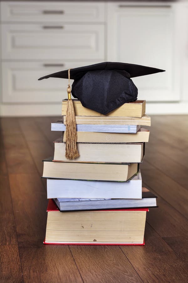 Graduation hat on books stock photo. Image of degree - 83340626