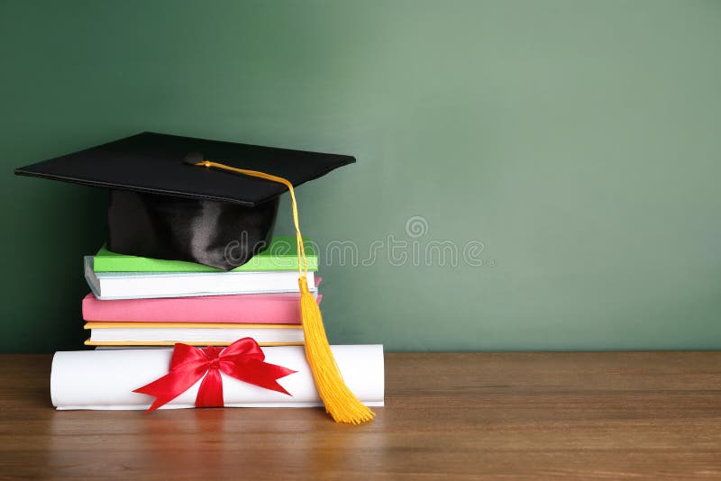 Graduation Hat with Books and Diploma on Table Near Chalkboard Stock ...