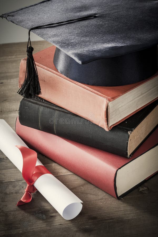 Graduation Hat and Diploma with Book on Table Stock Image - Image of ...