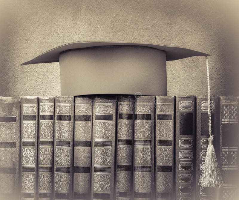 Graduation Mortarboard on Top of Stack of Books on Abstract Back Stock ...