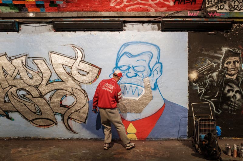 A Graffiti Artist, Wearing a Red Jacket and Cap. Leake Street, Uk ...