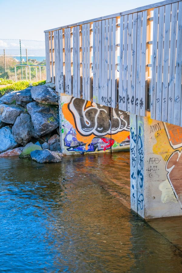 Graffiti on the bridge. stock image. Image of water - 144032853